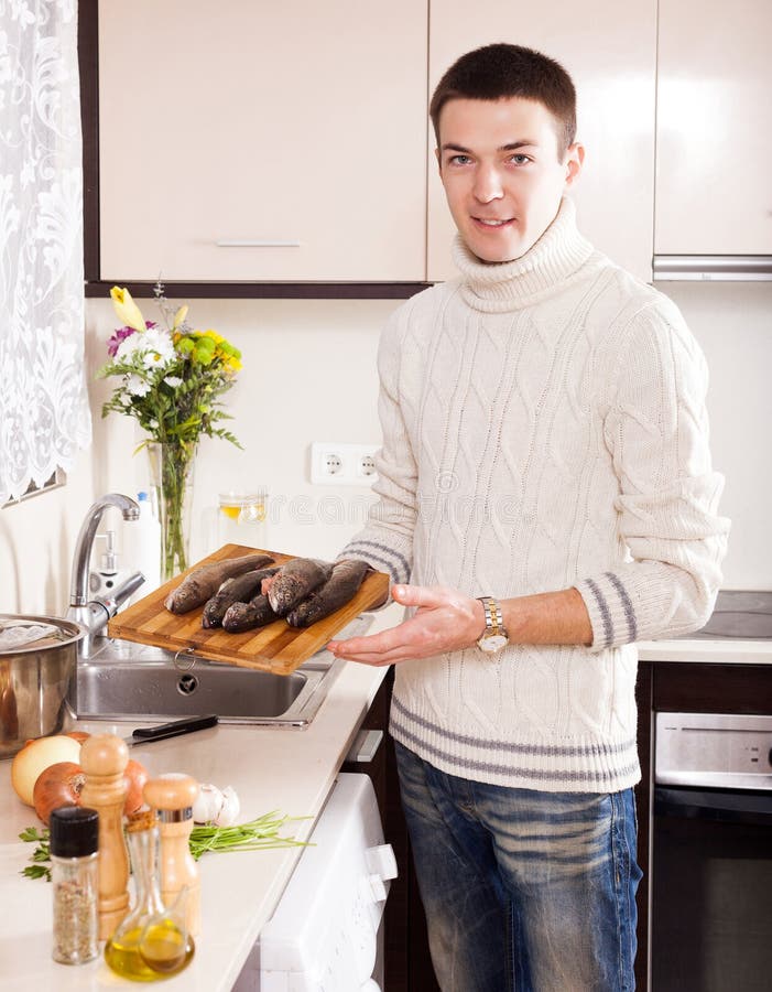 Smiling guy cooking stock image. Image of uncooked, fish - 43948675
