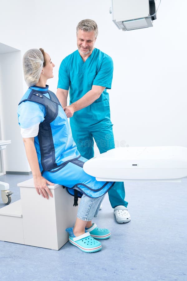 Smiling Guy Doctor Puts Protection on the Patient from X-rays Stock ...