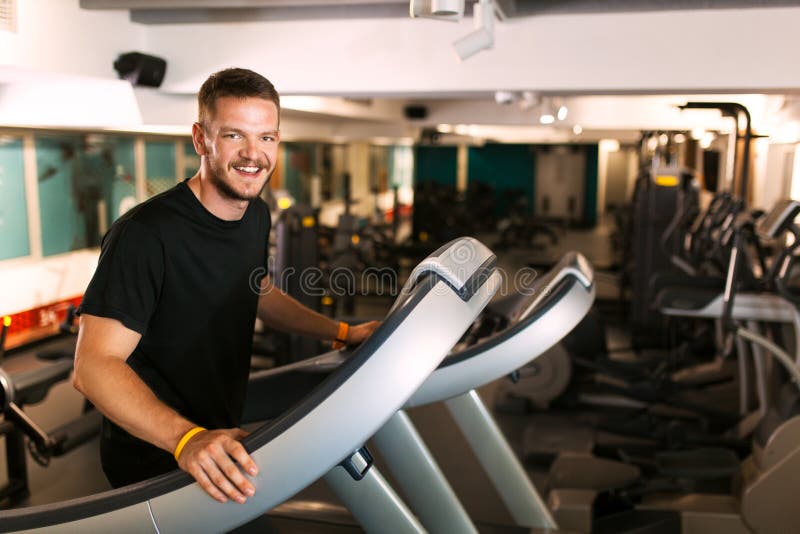 Smiling Guy Exercising on a Treadmill Stock Photo - Image of muscular ...