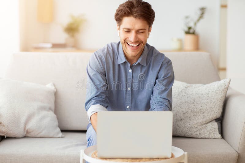 Smiling Guy Making Video Call Via Laptop Sitting on Couch Stock Photo ...