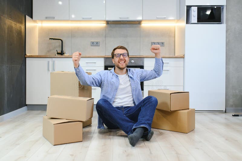 Smiling Guy Moving into His New Home Stock Photo - Image of standing ...