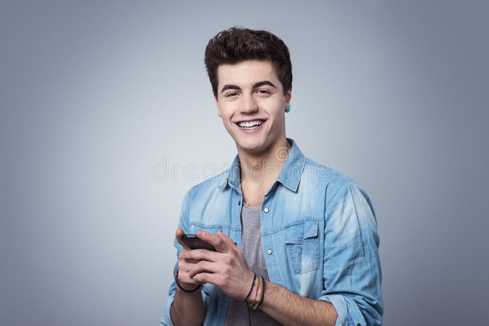 Smiling Guy Texting with Smartphone Stock Photo - Image of gray ...