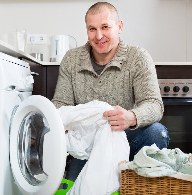 Smiling Guy Using Washing Machine Stock Photo - Image of clothing ...