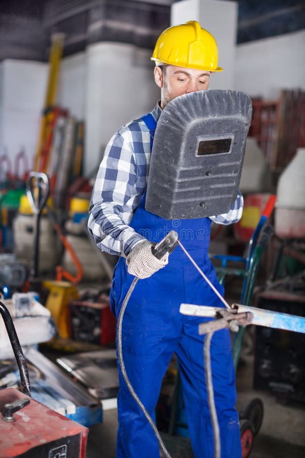Smiling Guy Using Welder for Construction Work Stock Photo - Image of ...