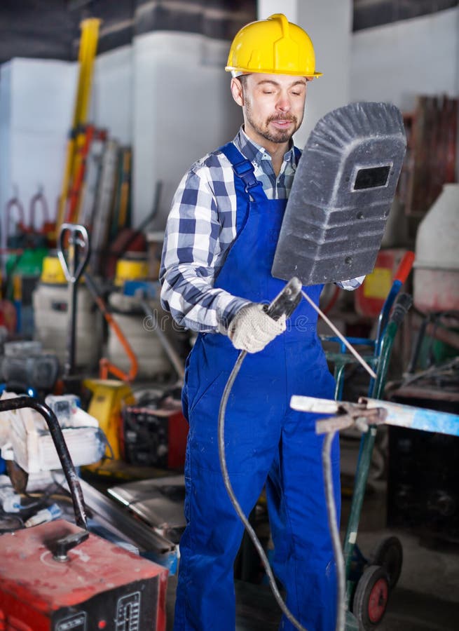 Smiling Guy Using Welder for Construction Work Stock Image - Image of ...