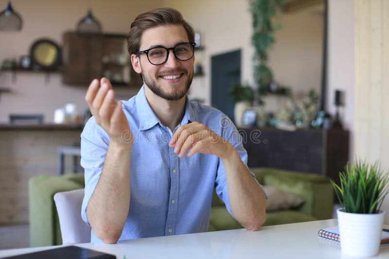 Smiling Handsome Businessman is Sitting at the Desk and Having Video ...