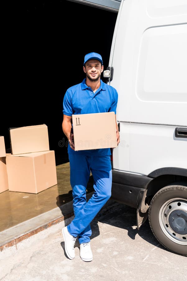 Delivery man with box stock image. Image of industry - 99749145