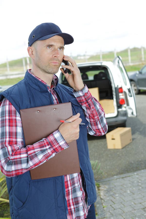Smiling Handsome Delivery Man Making Call Stock Photo - Image of mail ...