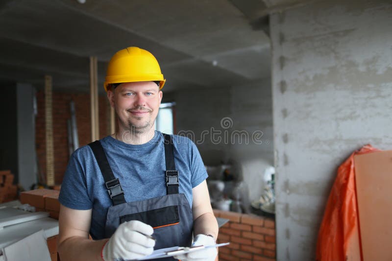 Smiling Handsome Male Builder in Hardhat Holding Pen and Clipboard ...