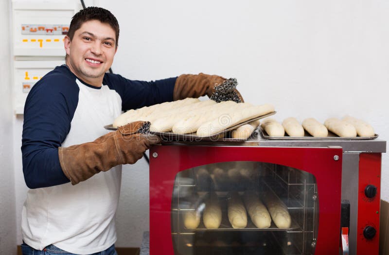 Smiling Handsome Man Baking Baguettes Stock Image - Image of positive ...