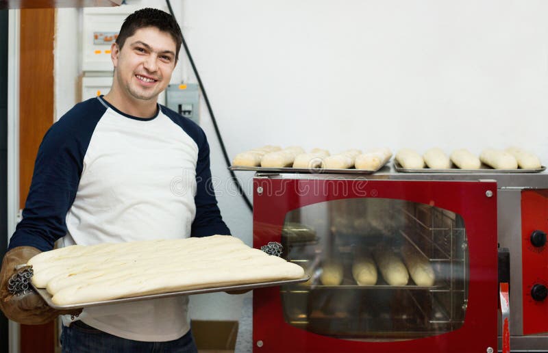 Smiling Handsome Man Baking Baguettes Stock Photo - Image of interior ...