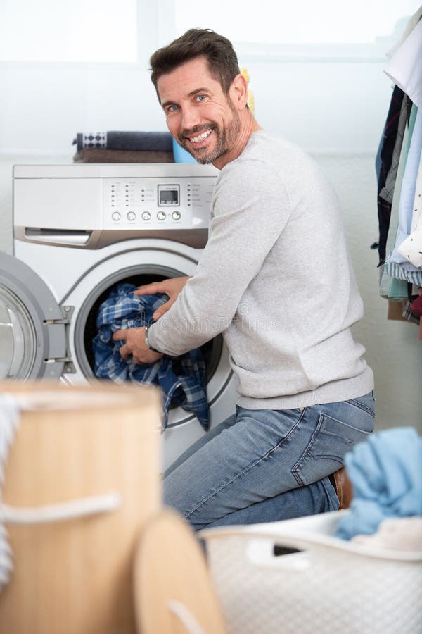 Smiling Handsome Man Doing Laundry Stock Image - Image of overwhelmed, handsome: 289725795