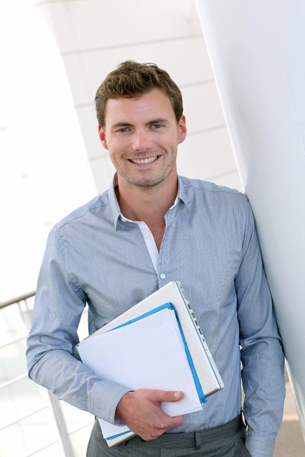 Smiling Handsome Man with Notebook Stock Photo - Image of standing ...
