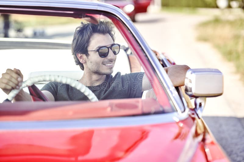 Front View of Smiling Handsome Man in Red Car Stock Image - Image of ...