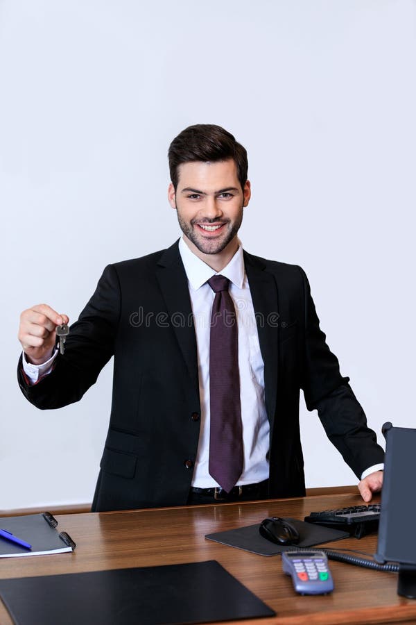 Smiling Handsome Receptionist Holding Key Stock Photo - Image of ...