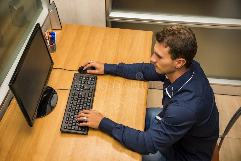 Smiling Handsome Young Businessman Sitting at Desk Stock Photo - Image ...