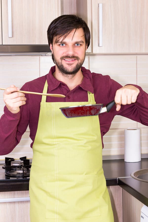 Smiling Handsome Young Man with Apron Cooking in the Kitchen Stock ...
