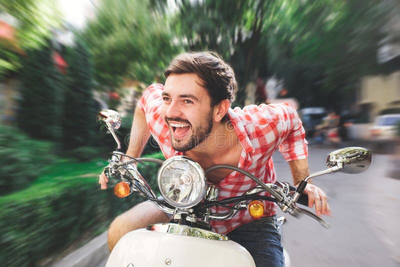 Smiling Handsome Young Man Riding Scooter Stock Photo - Image of moving ...