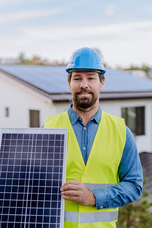 Smiling Handyman Solar Installer Standying with Solar Module while ...