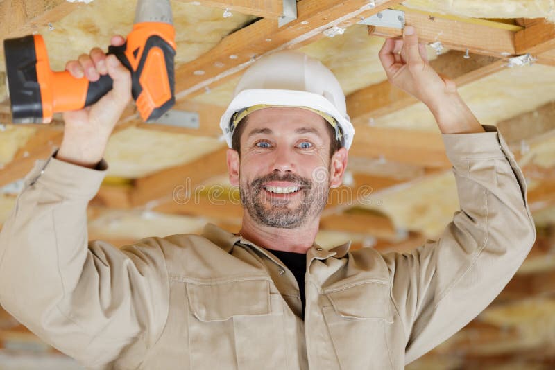 Smiling Handyman Using Cordless Drill To Ceiling Stock Image - Image of ...