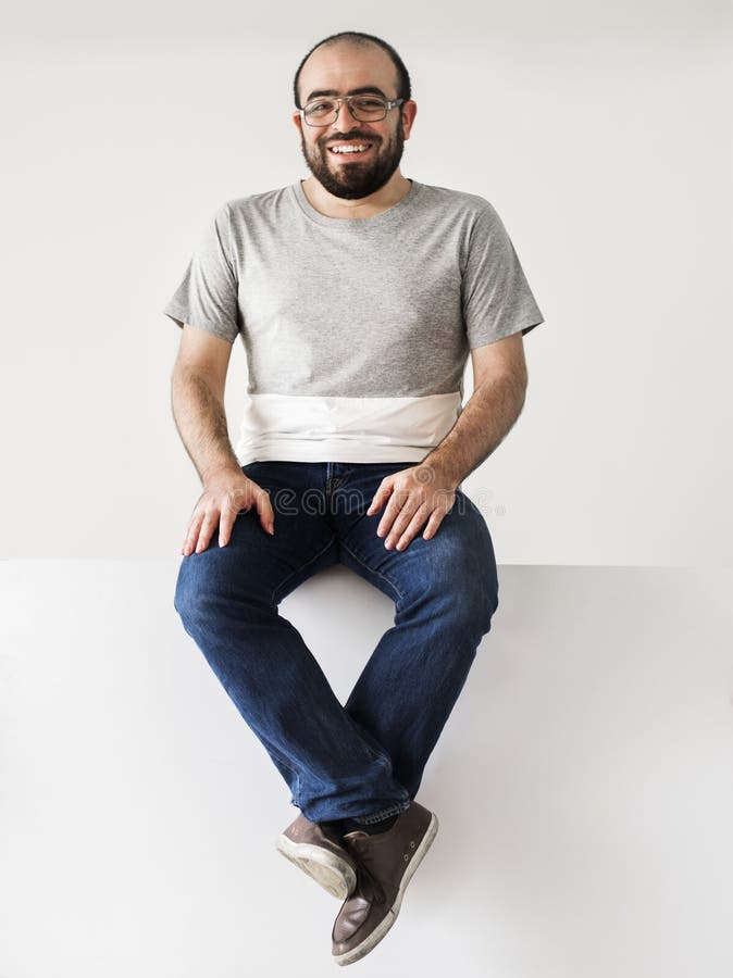 Smiling Happy Man Sitting Alone Stock Photo - Image of sitting, posture ...