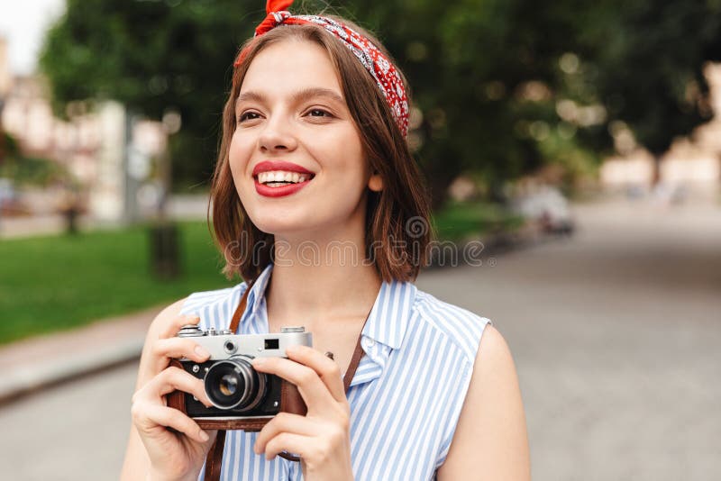 Smiling Hipster Woman Holding Retro Camera and Looking Away Stock Photo ... Smiling Hipster Woman Holding Retro Camera and Looking Away Stock Photo ...