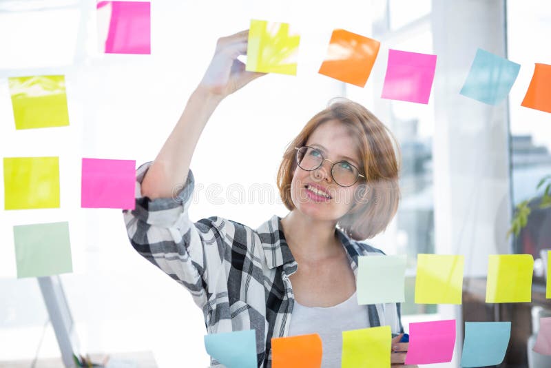 Smiling Hipster Woman Sticking Notes on a Notice Board Stock Photo ...