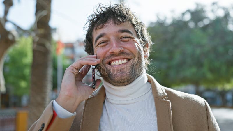 Smiling Hispanic Man with Beard Talking on Phone in Park Stock Photo ...