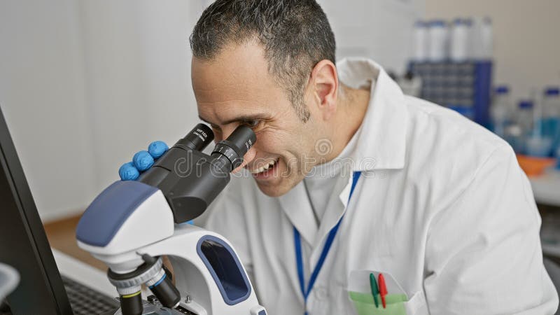Man in a Lab Coat Using a Microscope To Examine a Sample, Suitable for ...