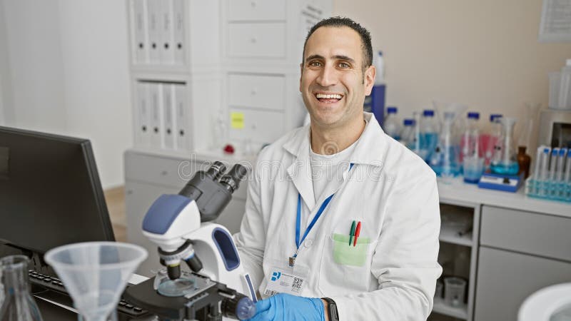 Smiling Hispanic Man in a Laboratory Wearing a Lab Coat and Gloves ...