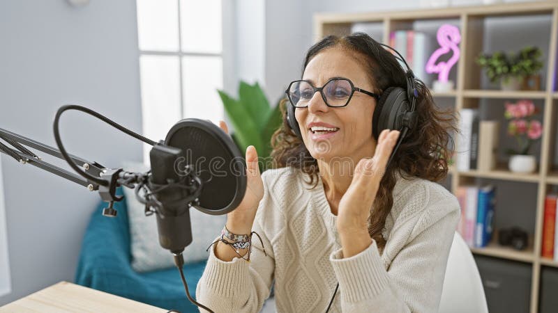 Smiling Hispanic Woman Recording with Microphone in Radio Studio ...
