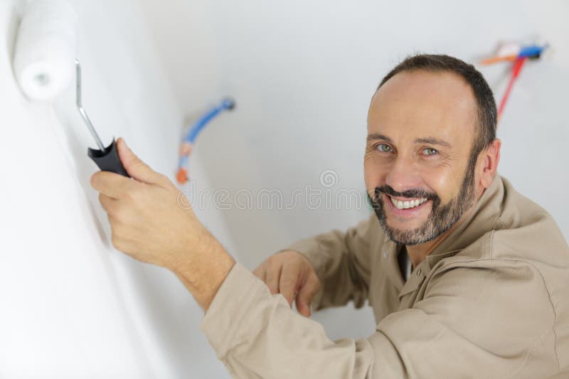 Smiling House Painter at Work Stock Photo - Image of overalls ...