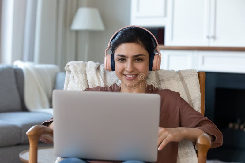 Smiling Indian Woman Using Wall Thermostat, Smart Home Heating System ... Smiling Indian Woman Using Wall Thermostat, Smart Home Heating System ...