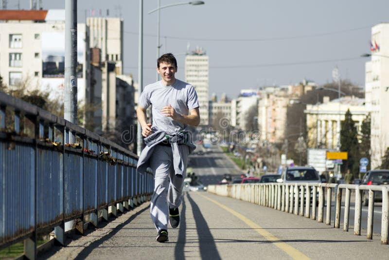 Smiling jogging man stock photo. Image of athlete, buildings - 103095176