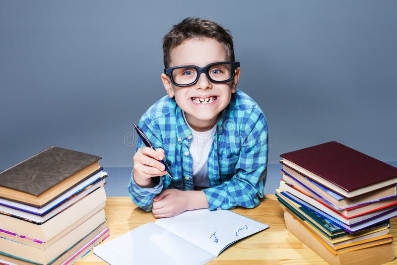Smiling Kid in Glasses Doing Homework at the Desk Stock Image - Image ...