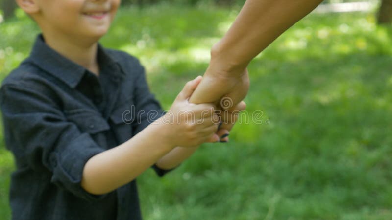Smiling Kid Pulling His Mother Hand Asking To Play with Him in Park ...