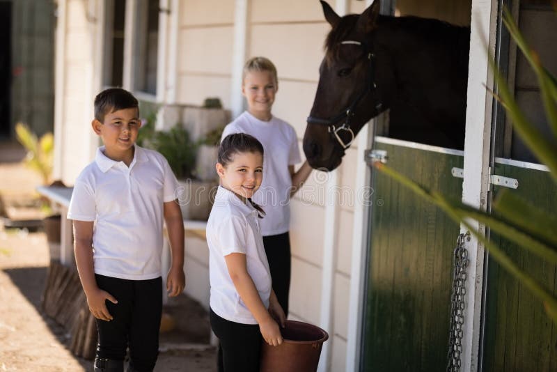 Smiling Kids Feeding the Horse in Stable Stock Photo - Image of brother ...