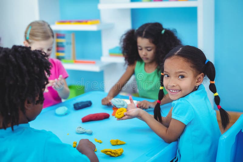 Smiling Kids Using Modelling Clay Stock Photo - Image of front, desk ...