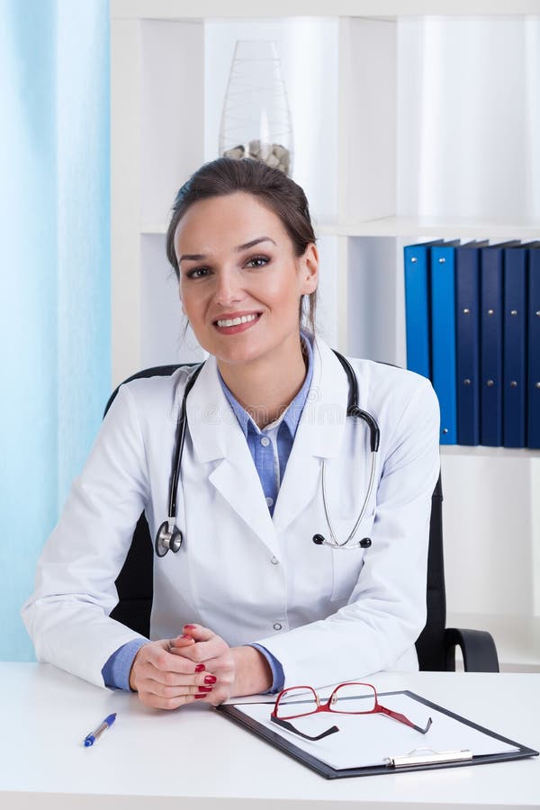 Smiling Lady Doctor Sitting at Desk Stock Photo - Image of portrait ...