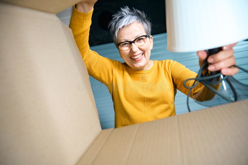 Smiling Lady Looks into a Box of Things Stock Image - Image of package ...