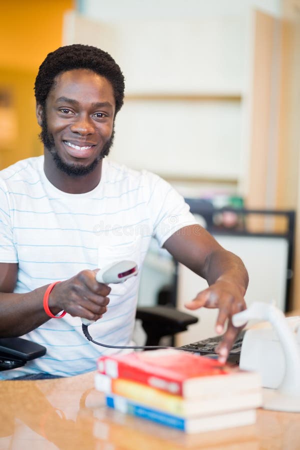Smiling Librarian Scanning Books at Library Desk Stock Image - Image of ...