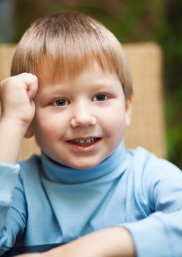 Smiling little boy stock photo. Image of child, seated - 18217196