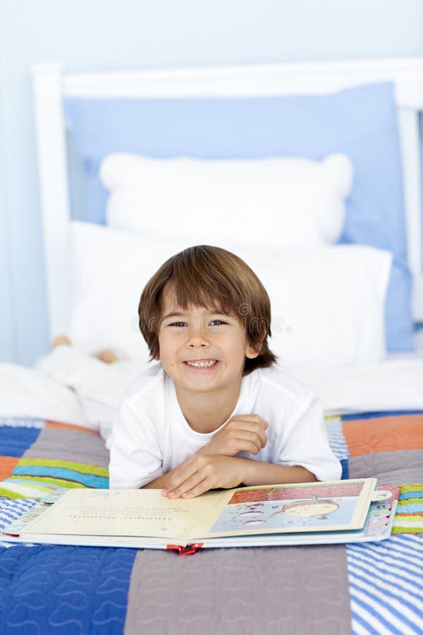 Smiling Little Boy Reading in Bed Stock Image - Image of inquisitive ...
