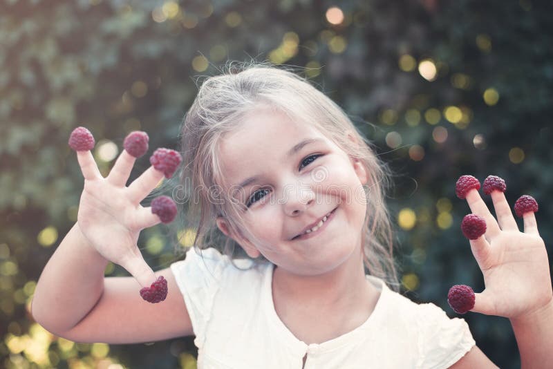 Smiling Little Child with Raspberry Outdoors Stock Photo - Image of ...