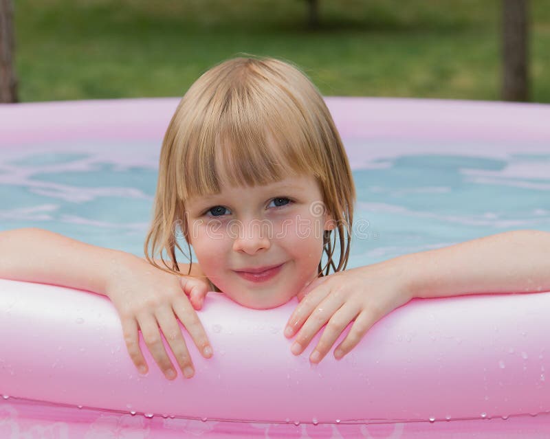 Smiling Little Girl in Inflatable Pool Stock Photo - Image of cheerful ...