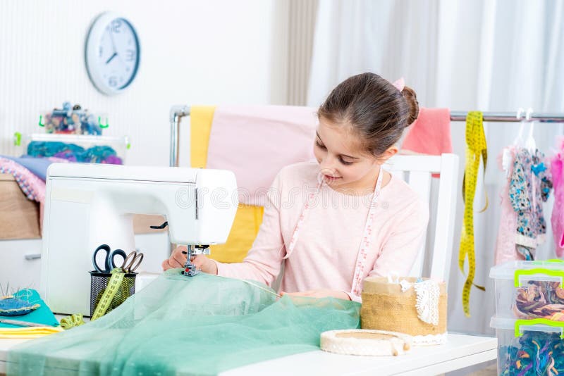 Smiling Little Girl Working at the Sewing Machine Stock Photo - Image ...