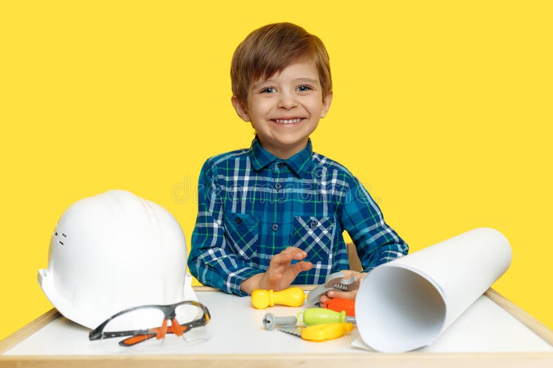 Smiling Little Kid Boy Engineer or Architect Sitting at the Work Table ...