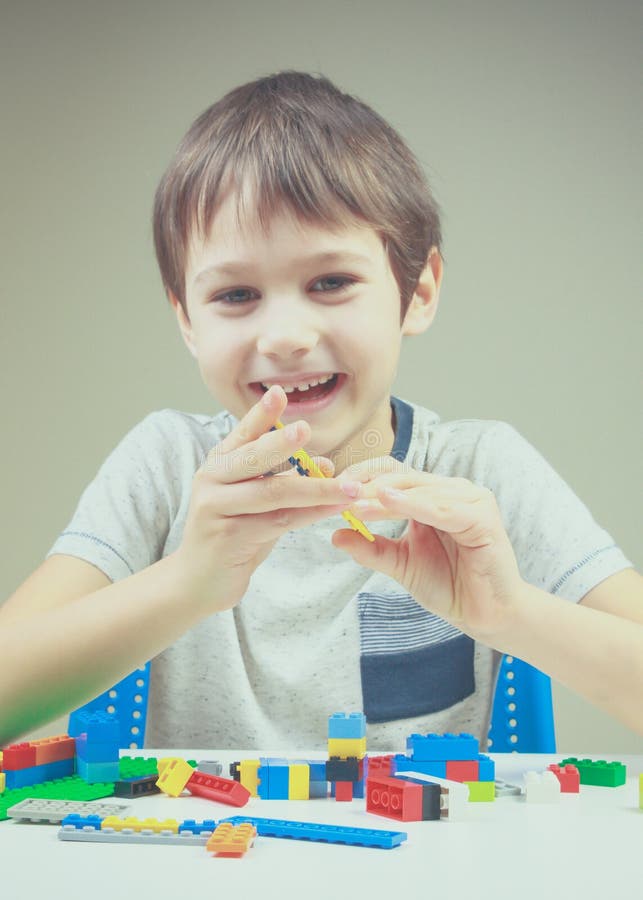 Smiling Little Kid Playing with Colorful Plastic Construction Bricks at ...