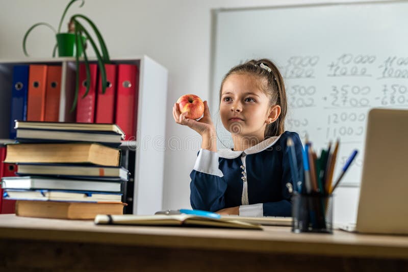 Smiling Little Schoolgirl Posing Taking Notes and Sitting Looking at ...