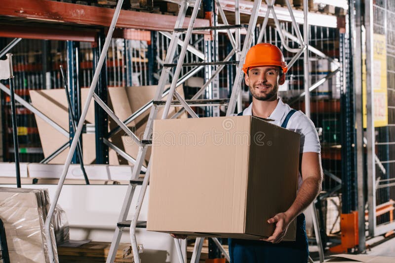 Smiling Loader Holding Cardboard Box and Stock Image - Image of boxes ...